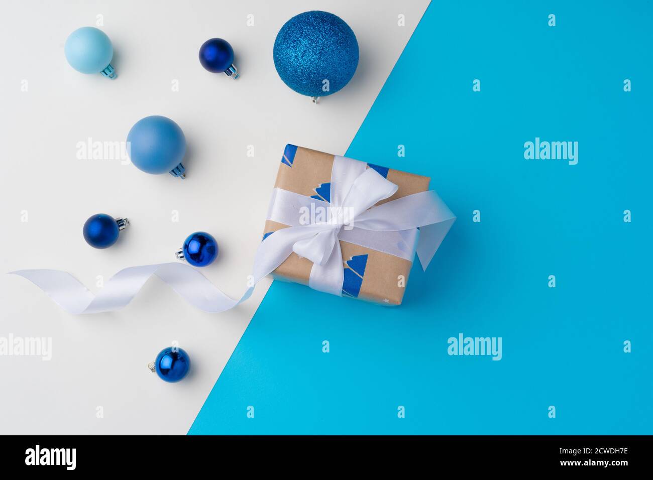 Top view of gift box with ribbon on blue background Stock Photo - Alamy