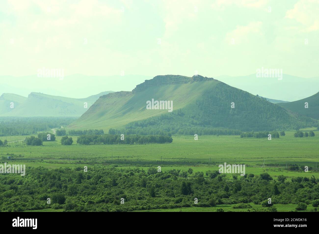 A high mountain in the endless steppe overgrown with grass and rare ...