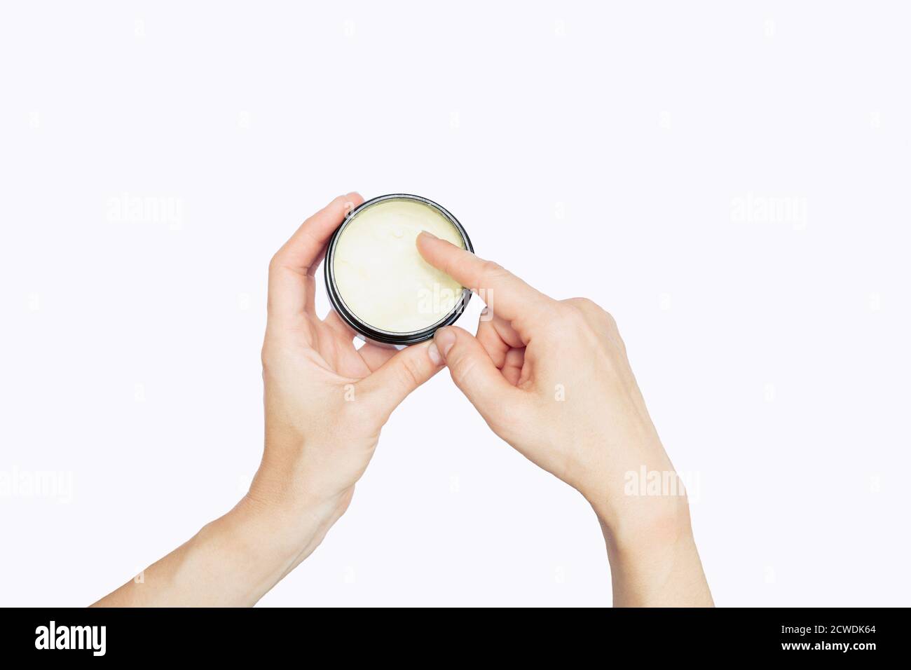 women hands hold wax product in for hair styling before going to work ...