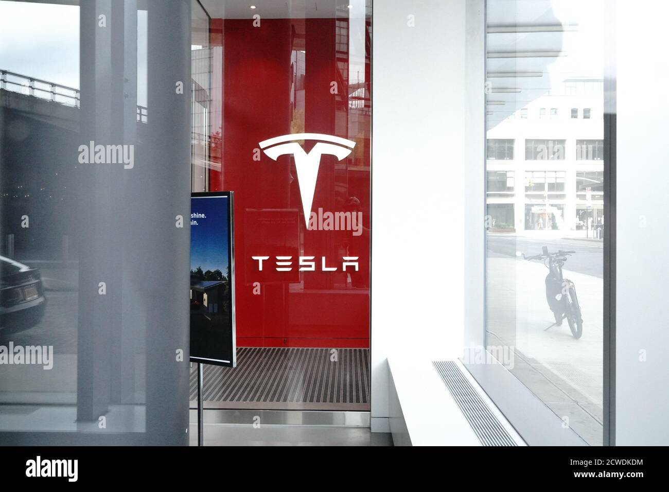Tesla logo at their showroom.Tesla’s next factory is going to be in ...