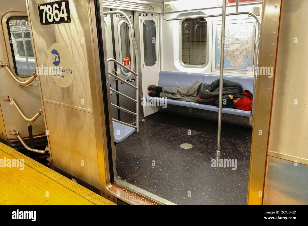 A homeless person sleeping on a subway train in Hudson Yards, New York ...