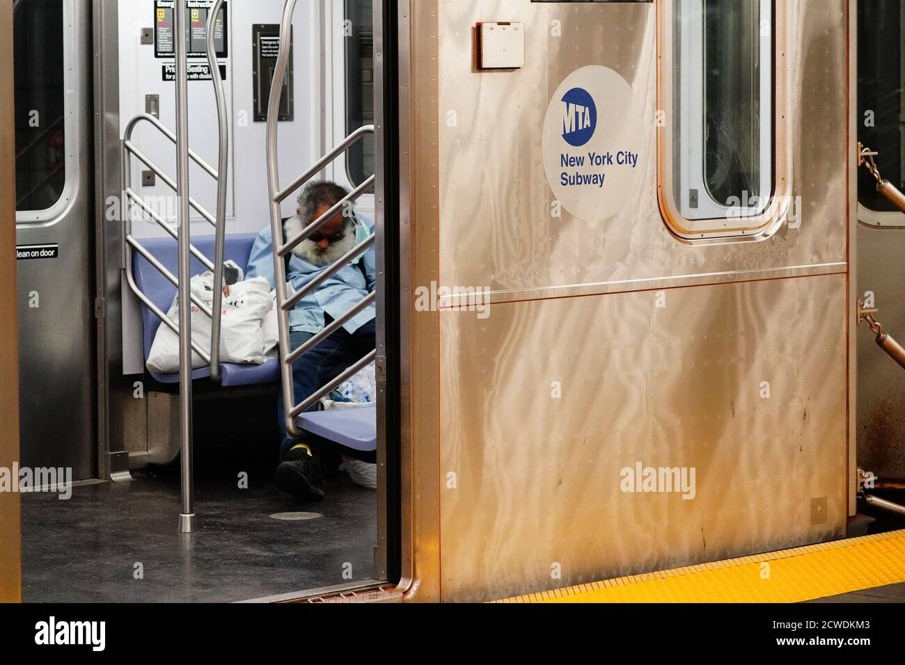 Homeless man inside an MTA train Stock Photo - Alamy