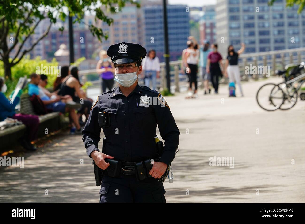 NYPD officer wearing a face mask as a preventive measure patrolling at ...