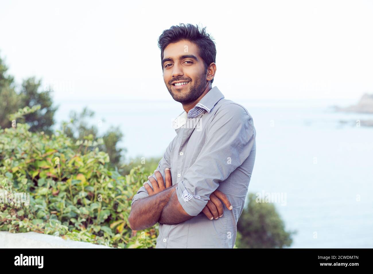Laughing happy outside. Portrait of elegant Indian man in formal gray ...