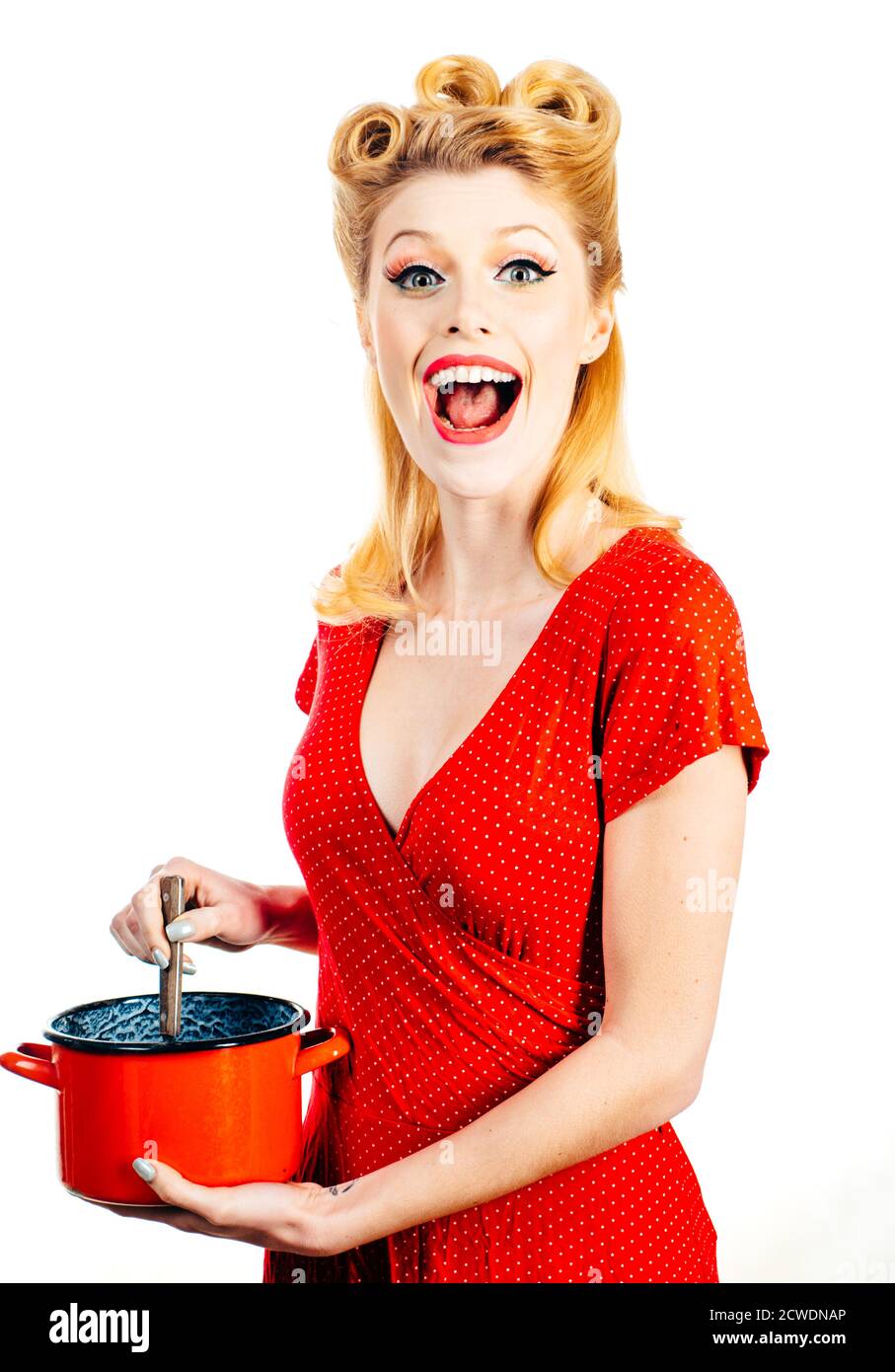 Funny woman winking in the kitchen and cooking Stock Photo - Alamy