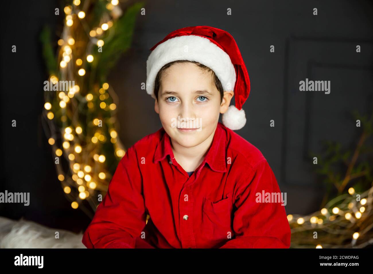 Funny laughing boy celebrates Christmas in Santa Claus hat. Xmas Stock ...