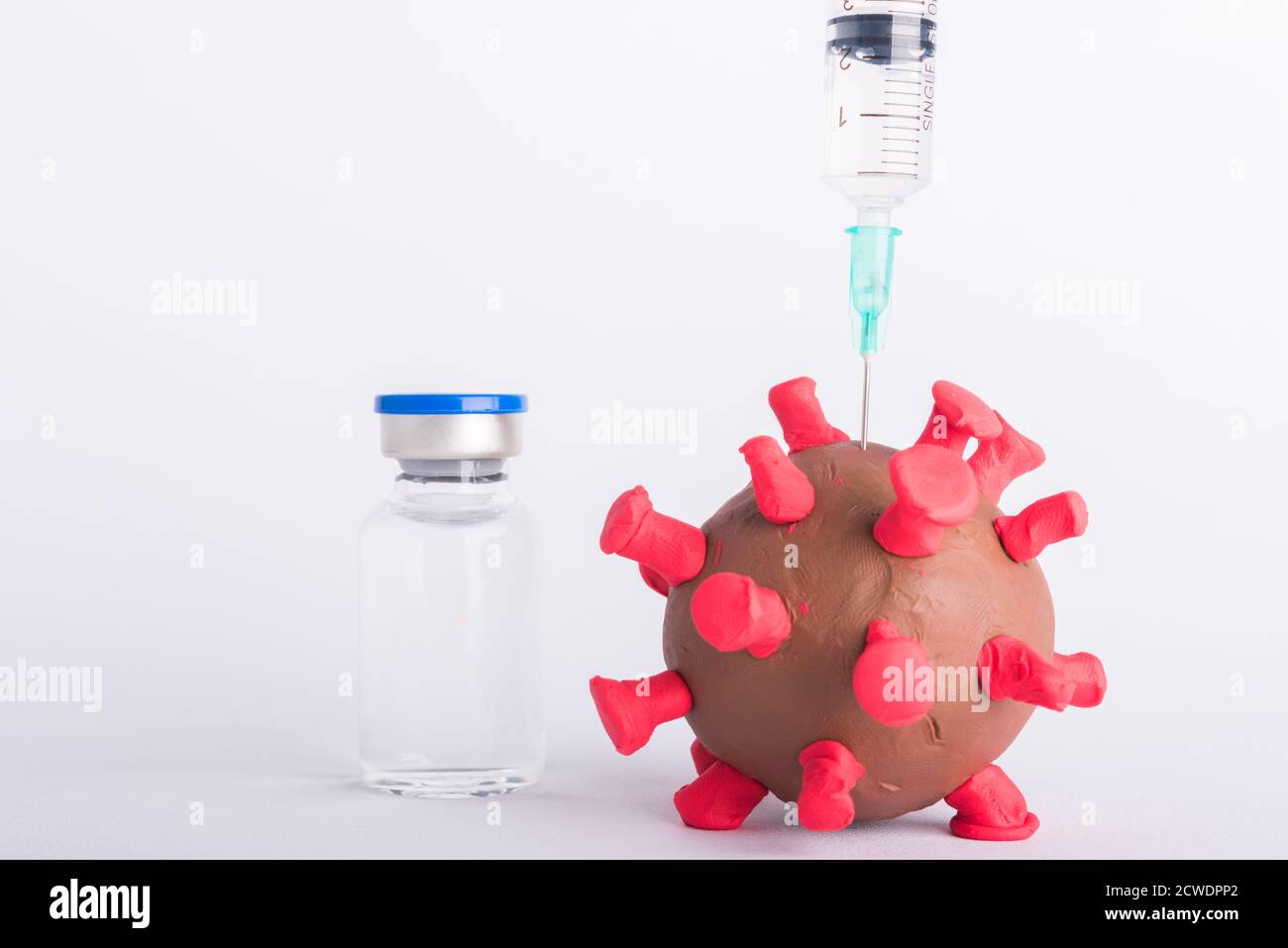 Closeup plasticine disease cells virus bottle vaccine and syringe of ...