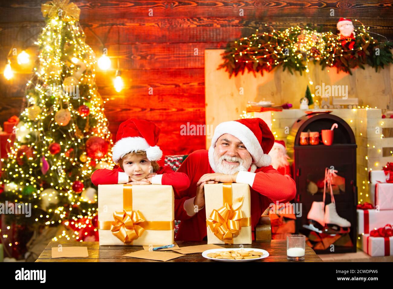 Christmas child. Surprised Little Santa in Christmas room. Santa Claus ...