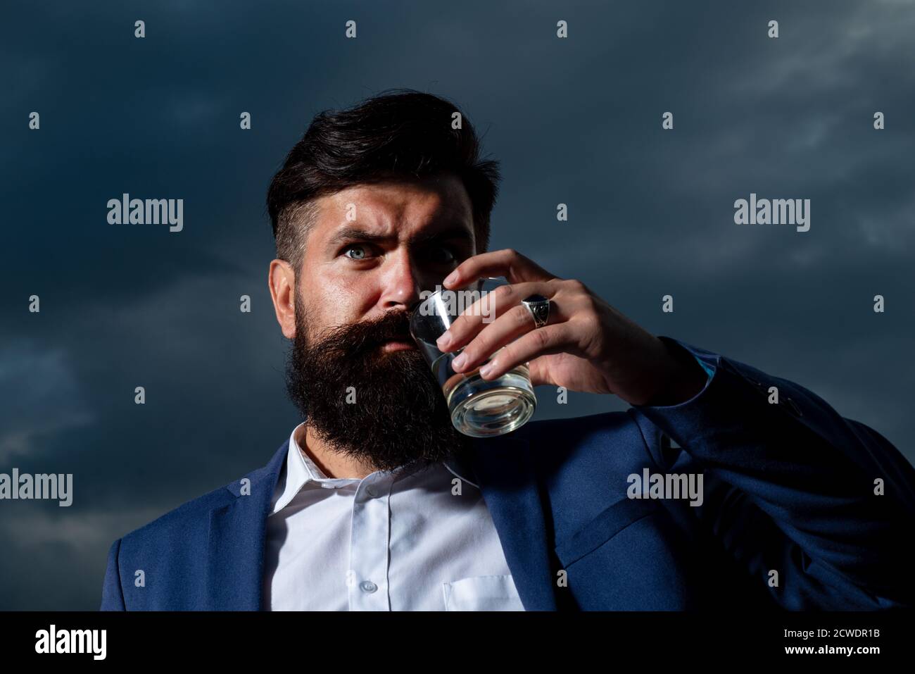Luxury rich bearded man drink expensive beverage. Man with beard holds ...