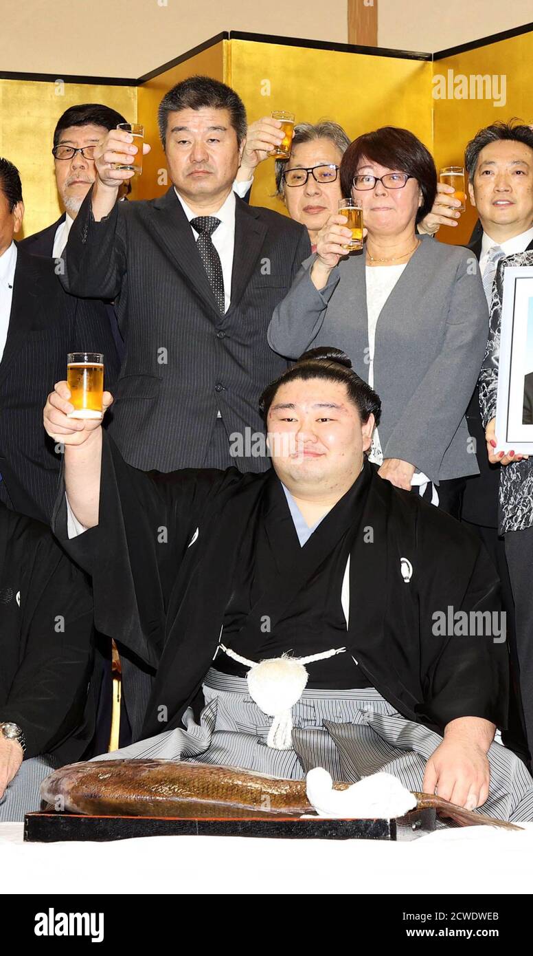 Sumo wrestler Shodai (bottom) celebrates his promotion to the sport's ...
