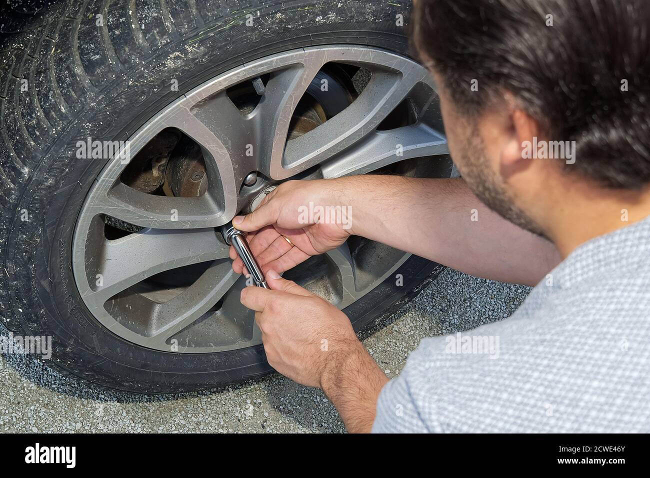 Man changing wheel. tire changer changing flat car tire. Help on road ...
