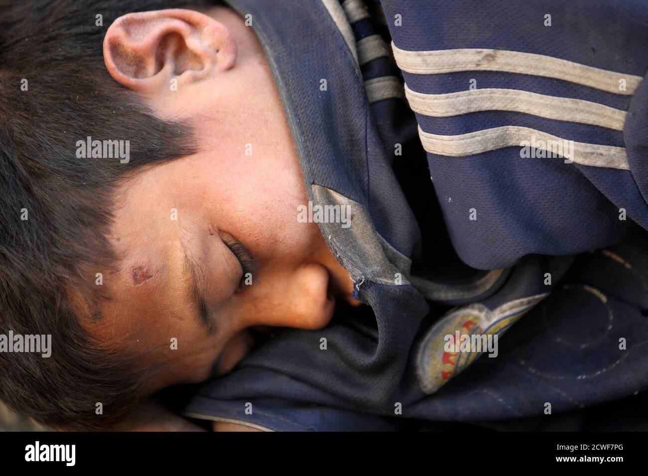 Homeless Boy Sleeping On Street High Resolution Stock Photography and ...