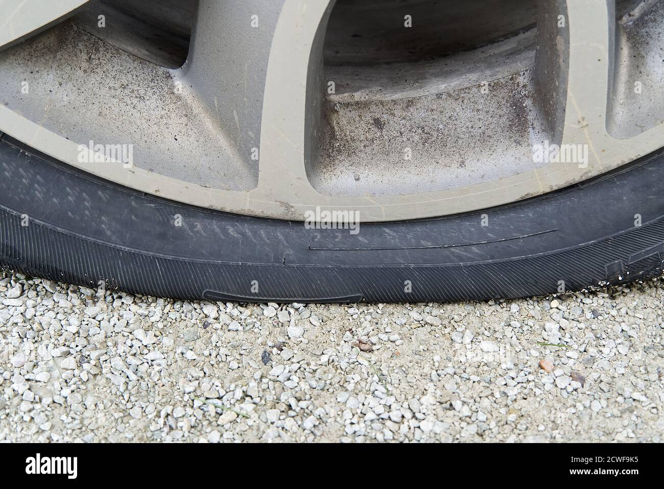 Close-up of Flat rear tire on car. The right rear broken weel. Damaged ...