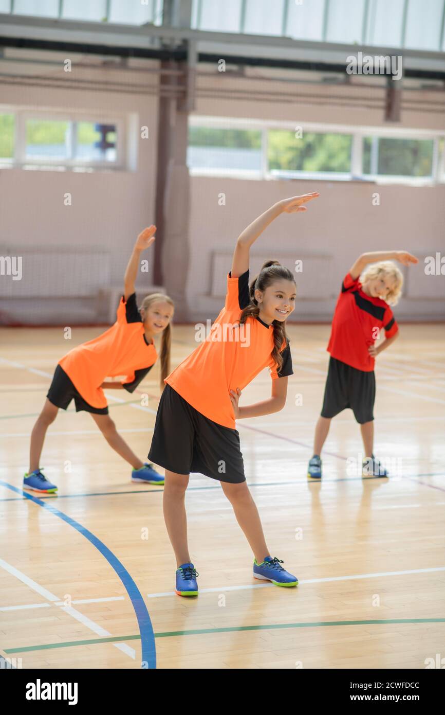 Kids stretching at school gym hi-res stock photography and images - Alamy