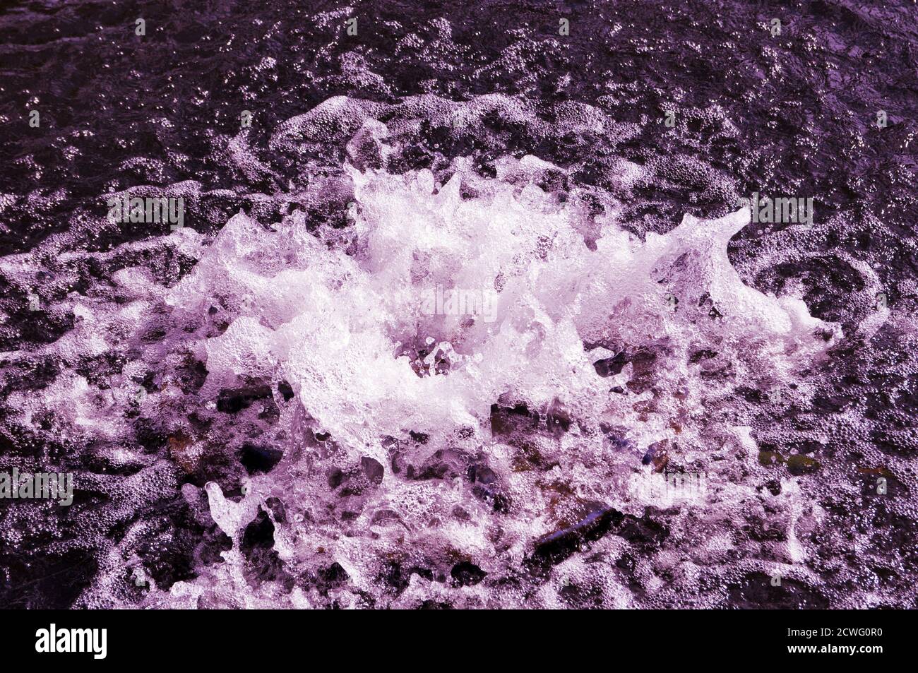 Spring, a stream of water hits through the water surface Stock Photo ...