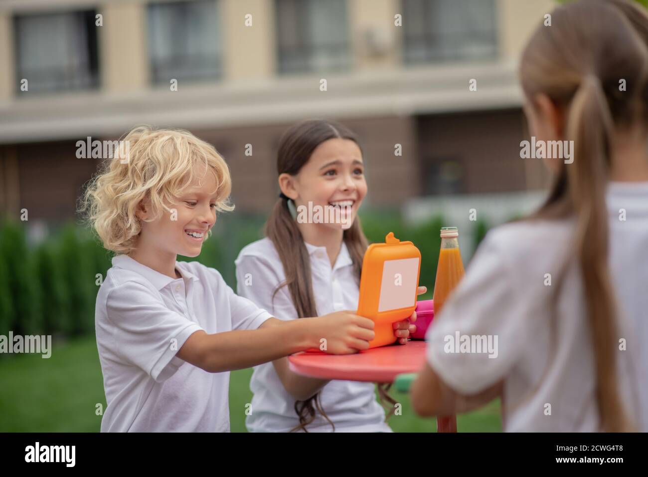 Children having lunch together and looking joyful Stock Photo - Alamy