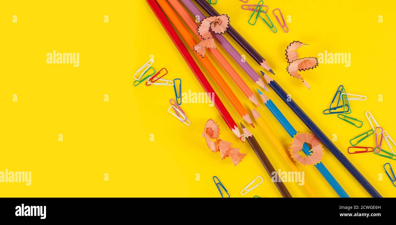 Some colored pencils of different colors and a pencil sharpener and ...