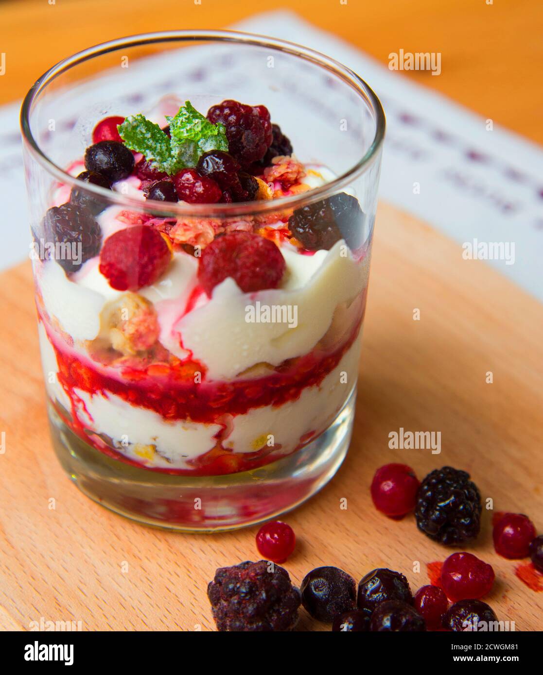 Greek yogurt with cereal and fruits Stock Photo - Alamy