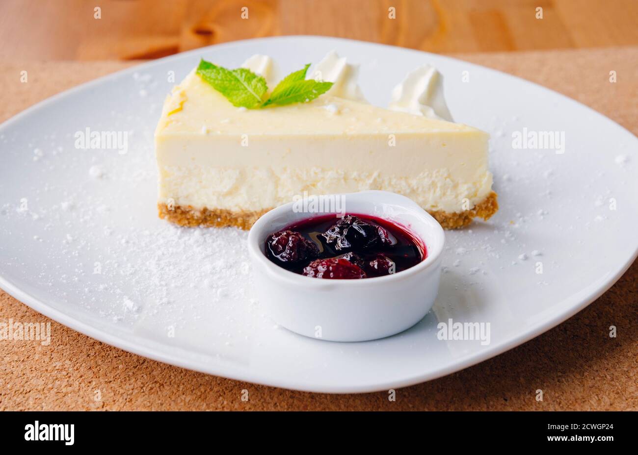 Slice of cheesecake with fruits on the white plate Stock Photo - Alamy