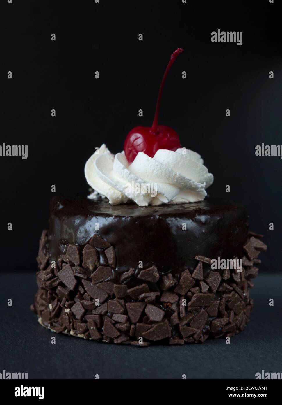 Delicious chocolate cake with cherry on the top icing Stock Photo - Alamy