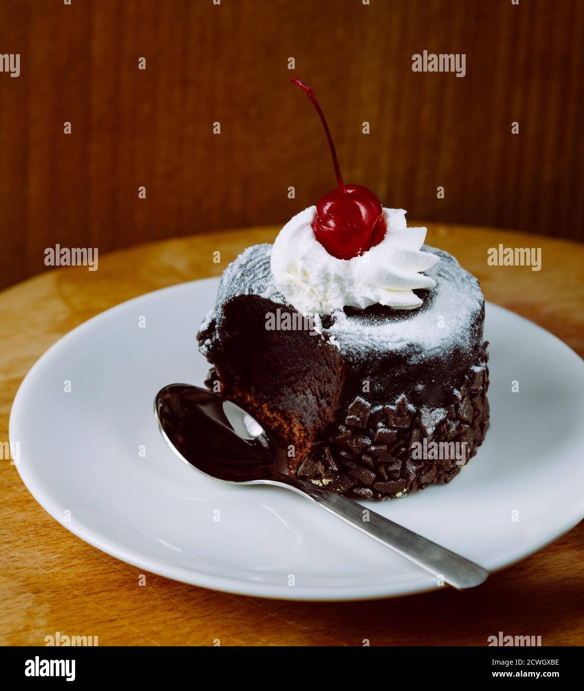 Delicious chocolate cake with cherry on the top icing Stock Photo - Alamy