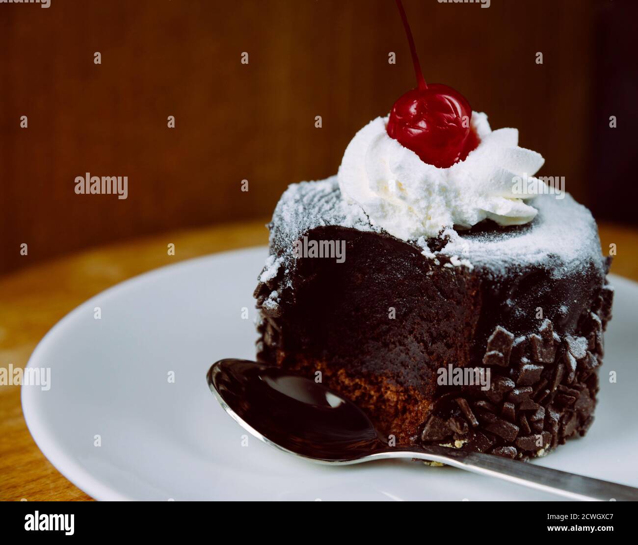 Delicious chocolate cake with cherry on the top icing Stock Photo - Alamy