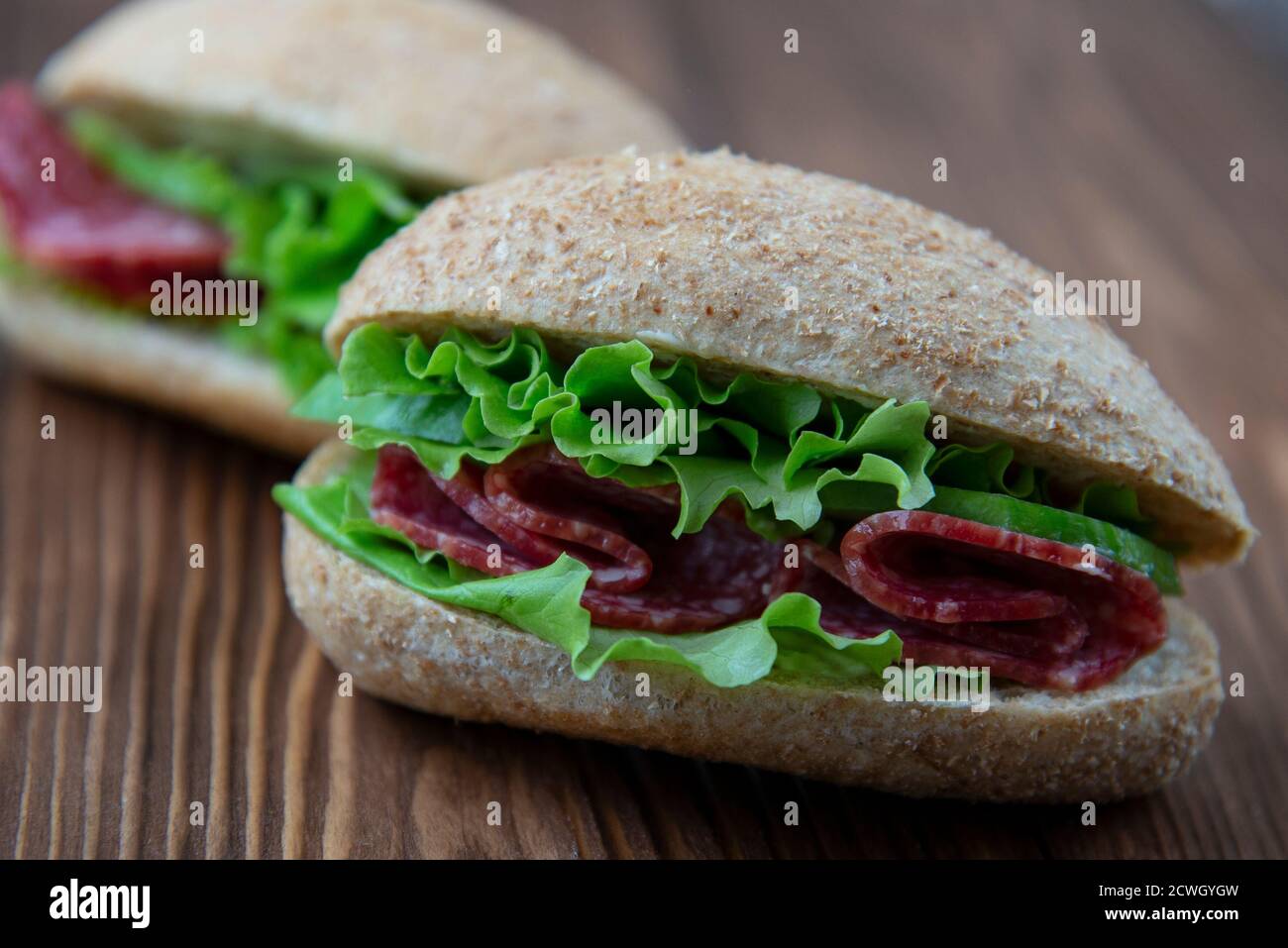 Fresh whole grain sandwiches with salami and lettuce Stock Photo - Alamy