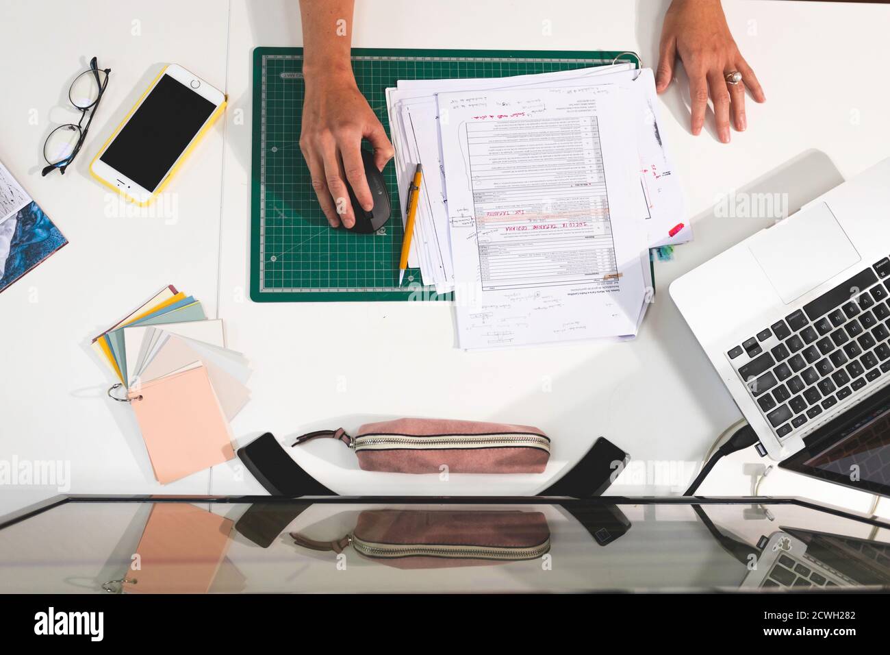 A young attractive business woman working on her desk at her laptop ...