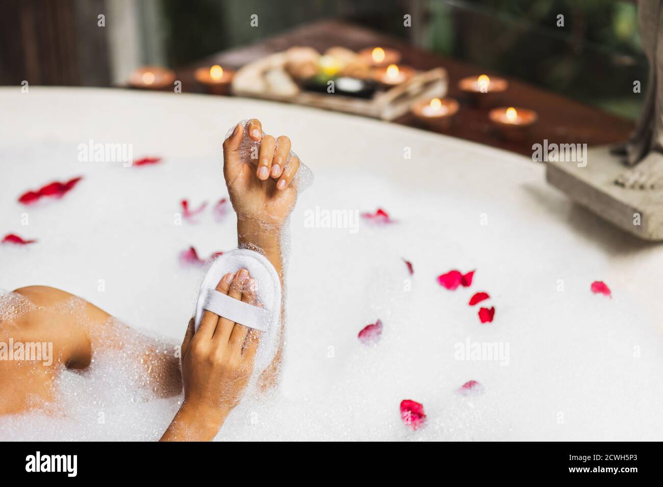 Woman Washing Hands In Bath Tub With Foam Bubbles And Use Natural Jute