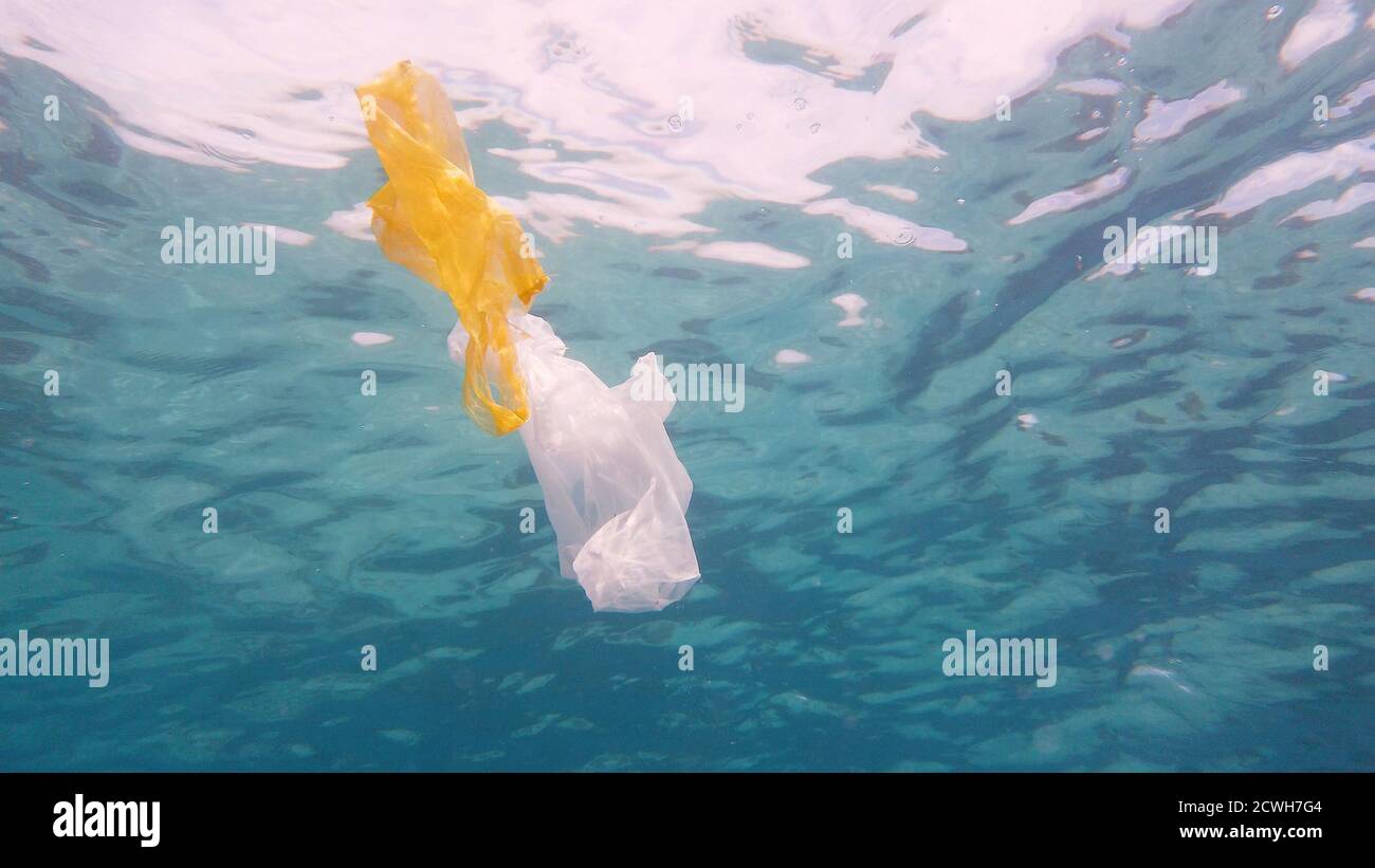 Plastic bag in blue ocean water. Plastic pollution in ocean ...