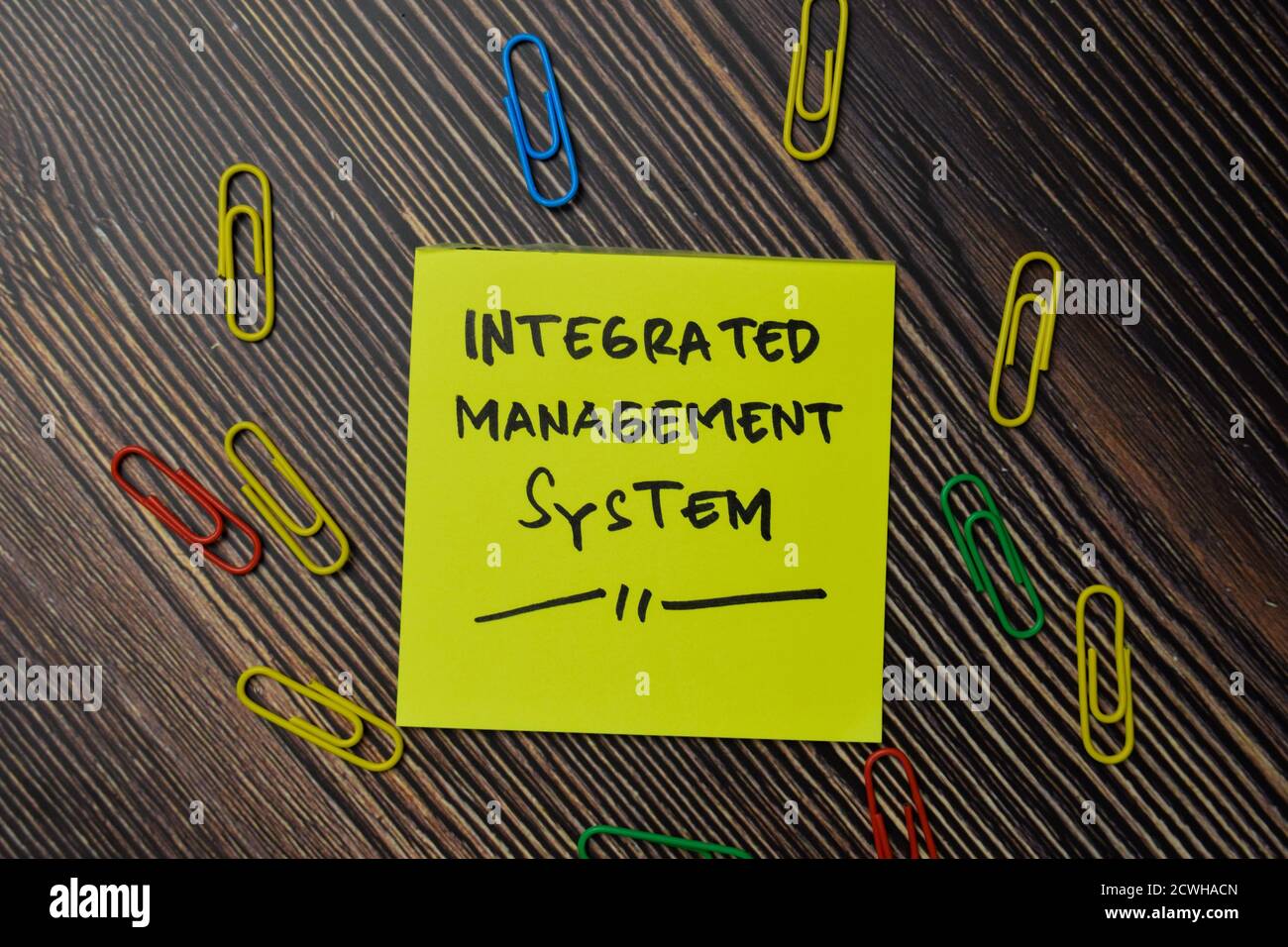 integrated management system write on sticky notes isolated on office ...
