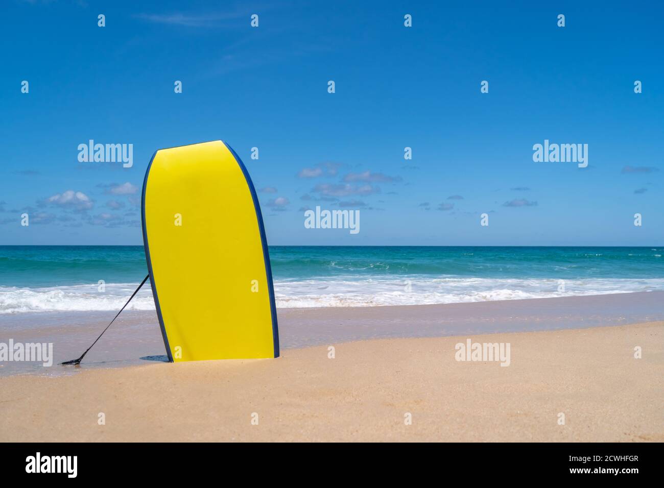 Small surfboards on sand at summer beach with sun light and blue sky ...