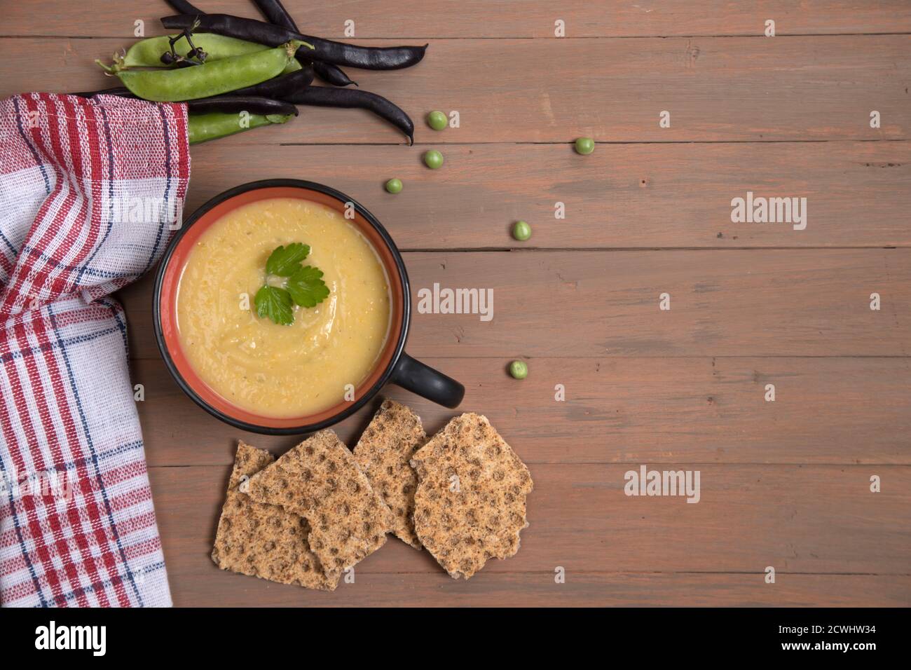 Soup-puree of beans and peas on a red napkin and a brown wood ...