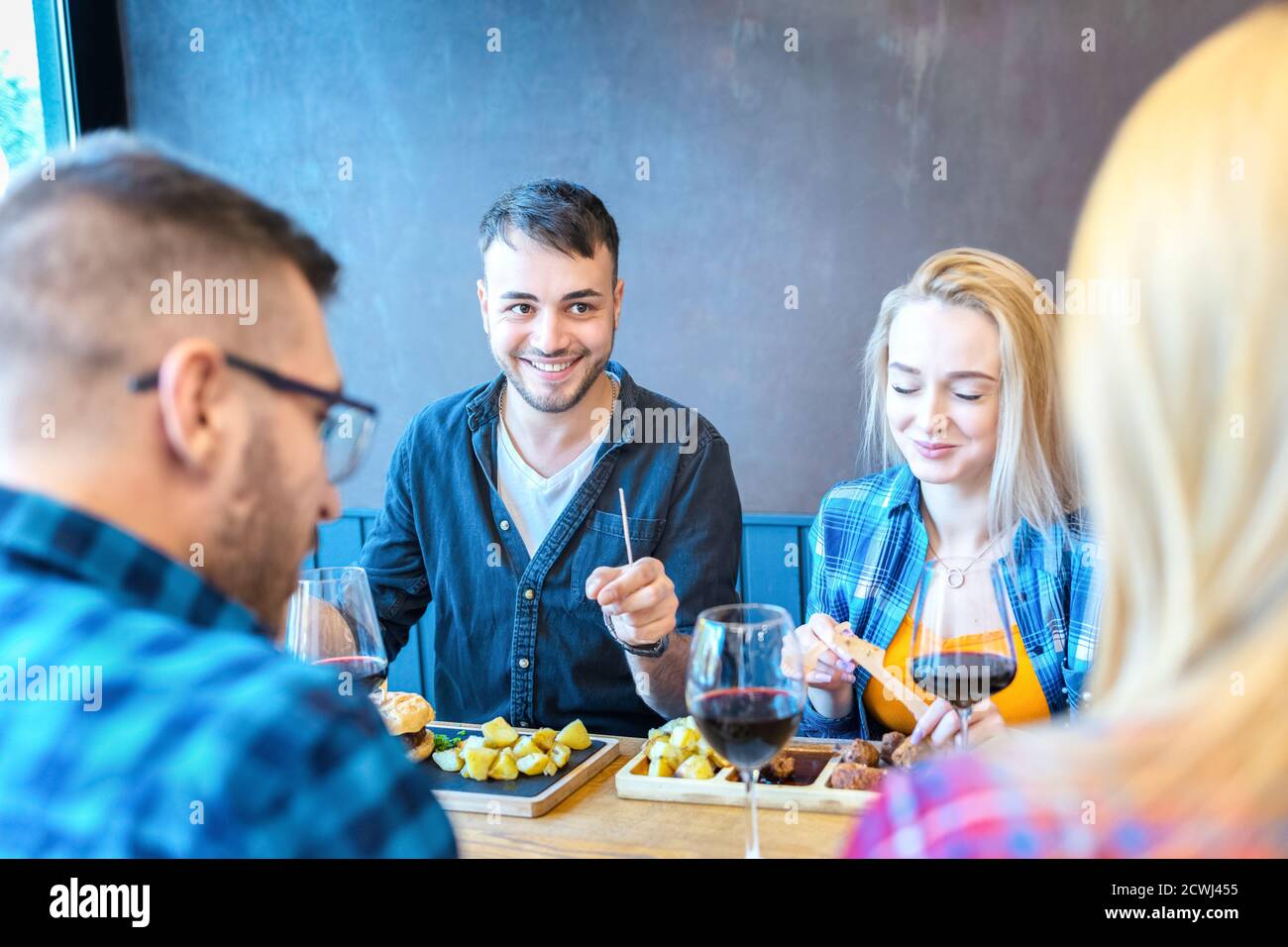 Happy couples having fun while enjoying lunch at fast food restaurant ...