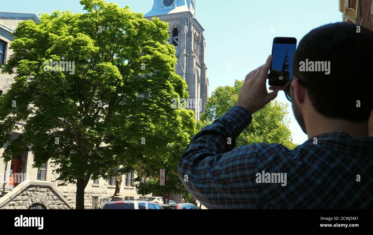 Man making a video of fluff flying in the air Stock Photo - Alamy