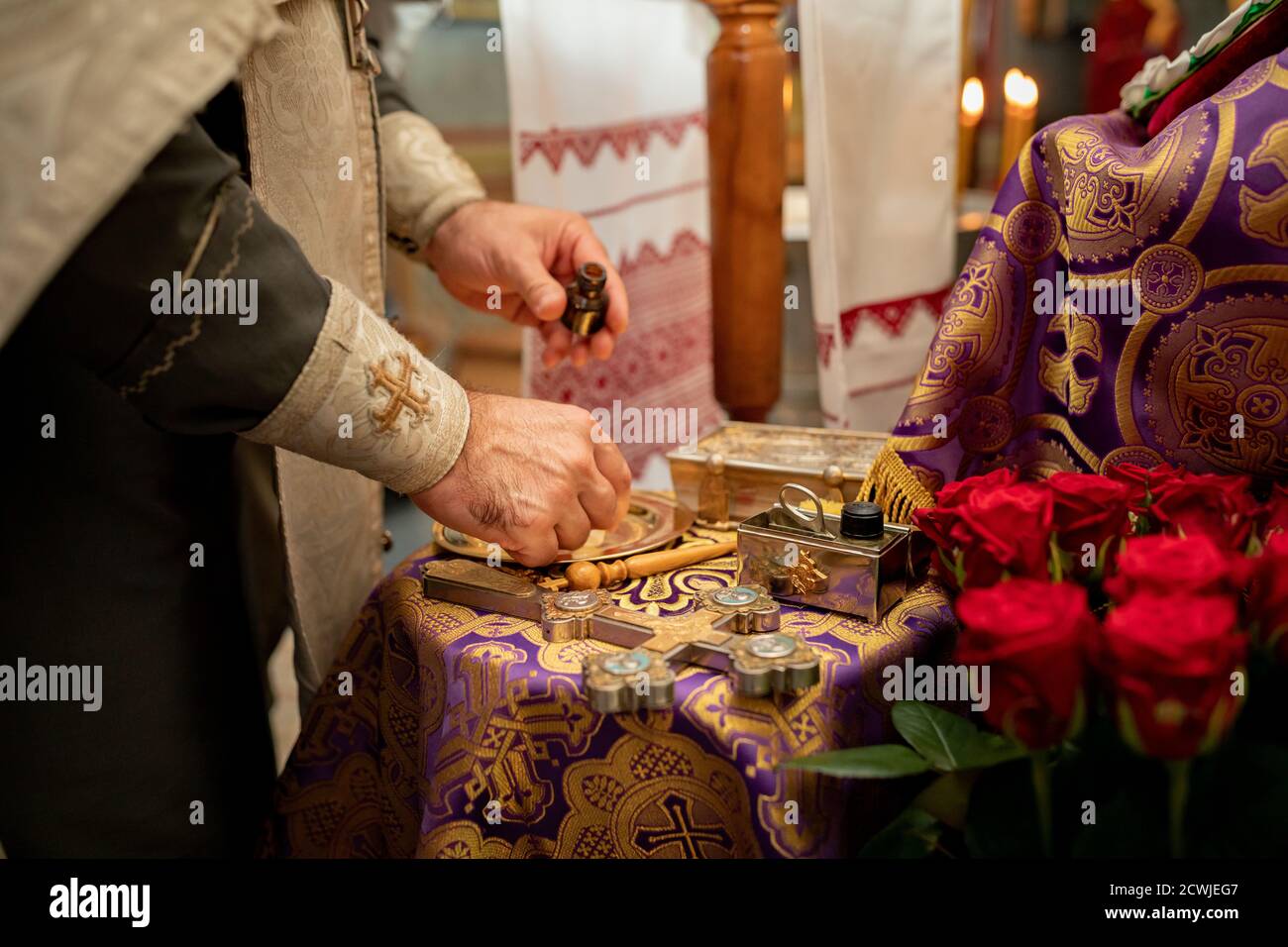 holy oil in the priest's hands. the priest prepares for the baptism ...