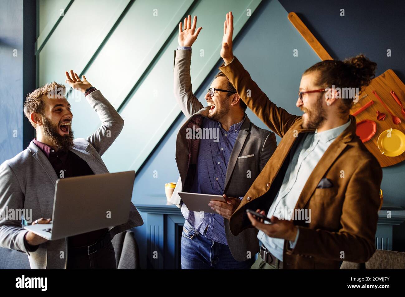 Happy successful business man giving a high fives gesture as cheer ...