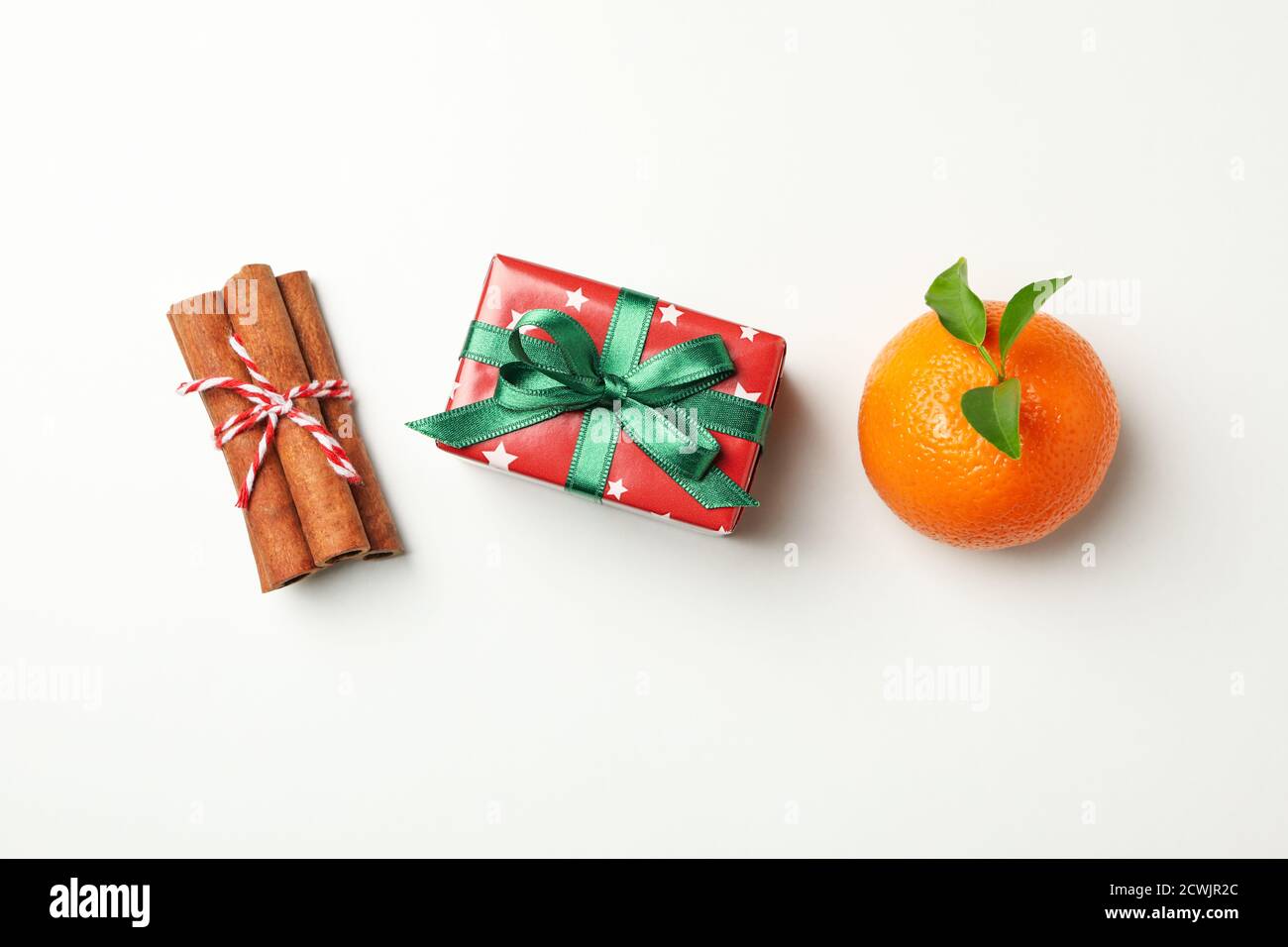Mandarin, cinnamon and gift box on white background Stock Photo - Alamy
