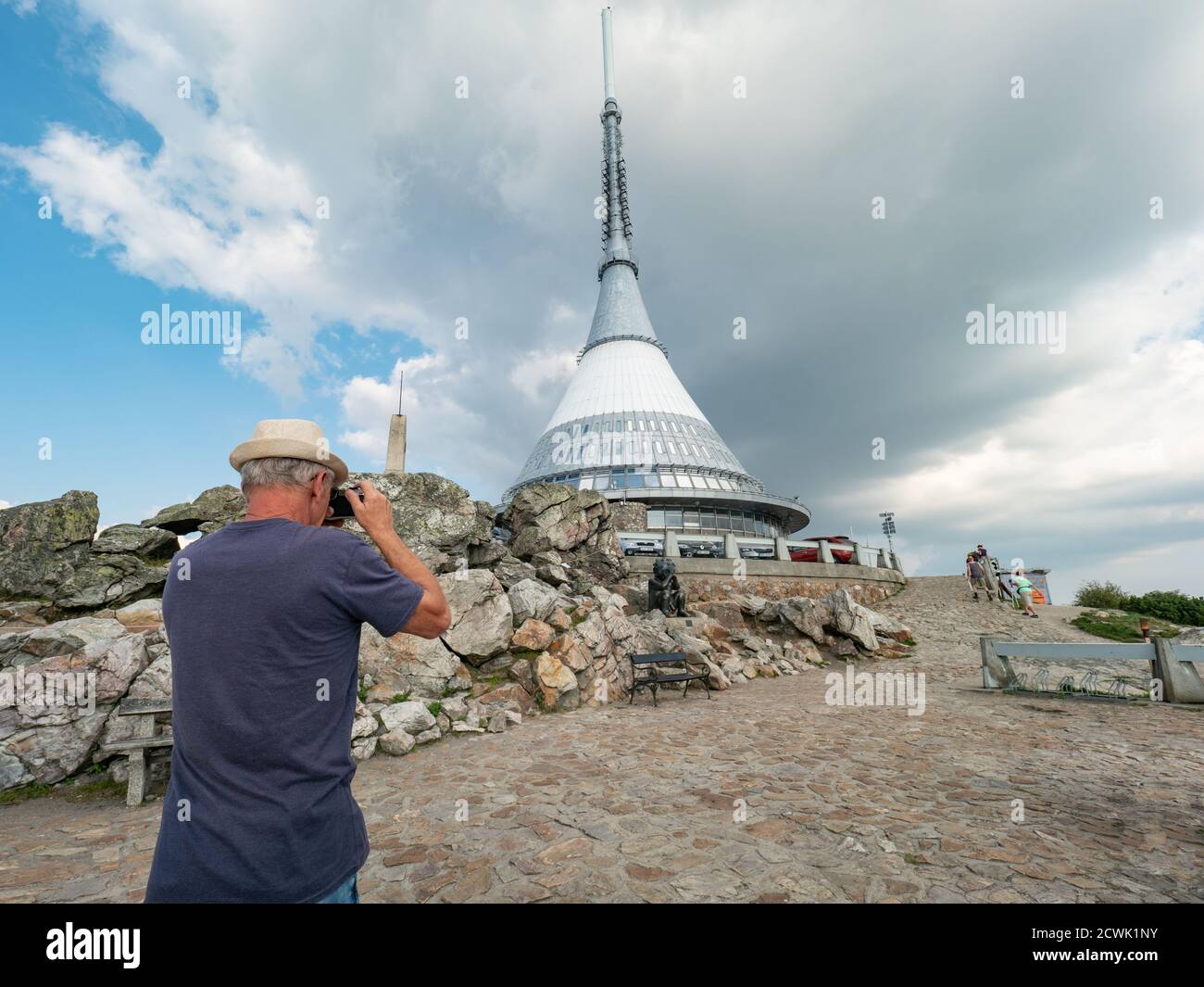 Pensioner using film camera during mountain trip. Old man visit Jested ...