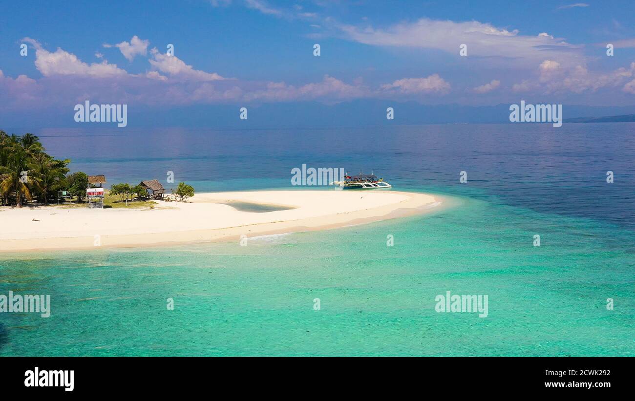 Island with a tropical beach and turquoise lagoons. White sand beach ...