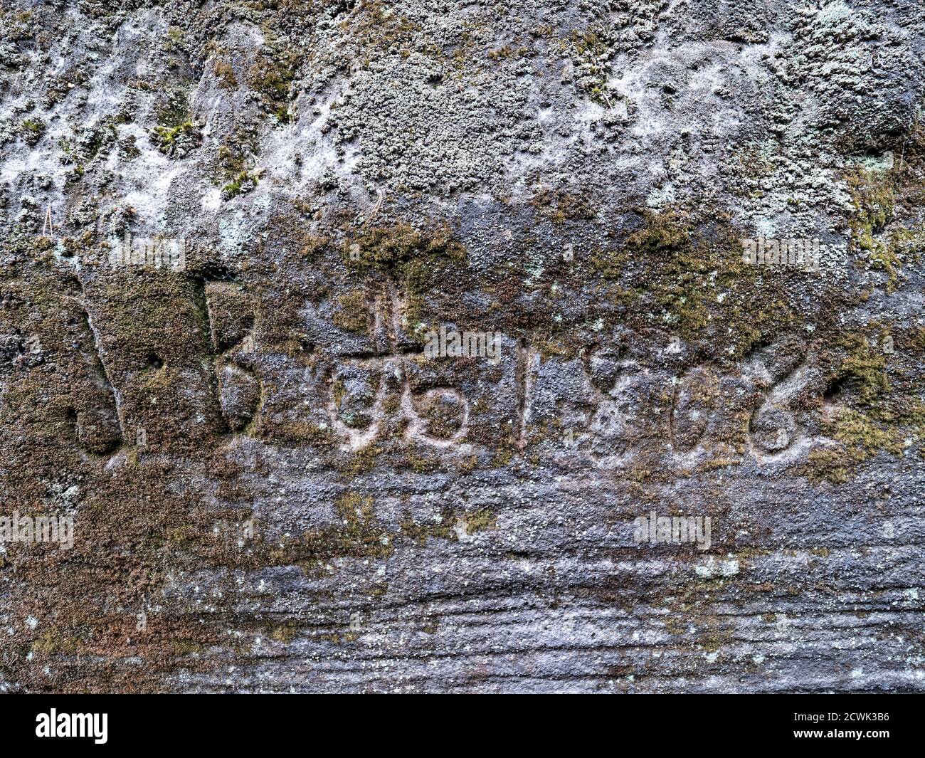 Old engraved numbers and letters indicating the owner of the sandstone ...