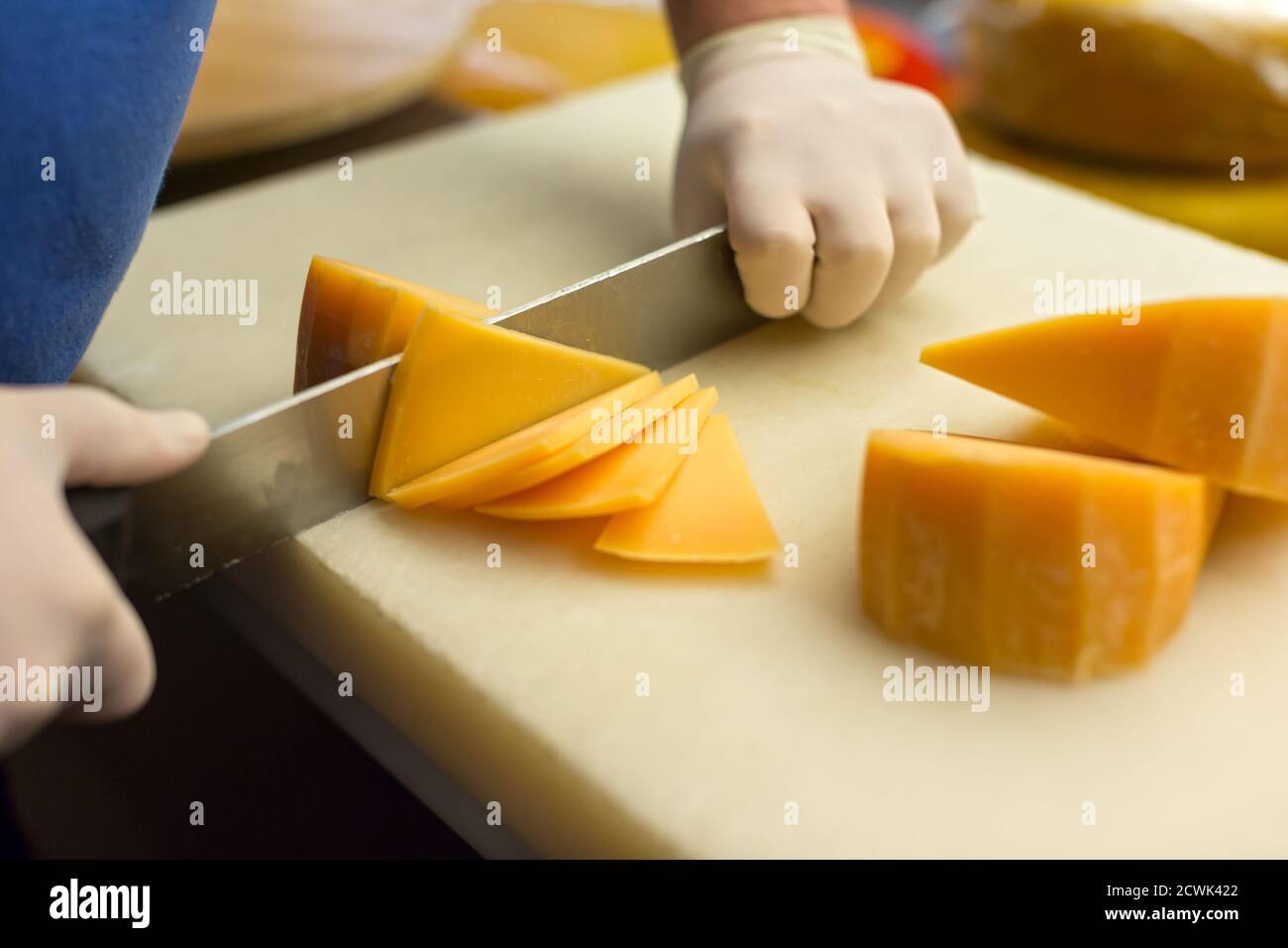 Hands Slicing Cheese Stock Photo - Alamy