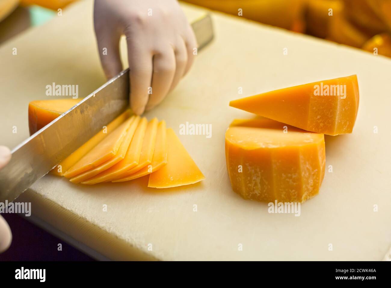 Hands Slicing Cheese Stock Photo - Alamy