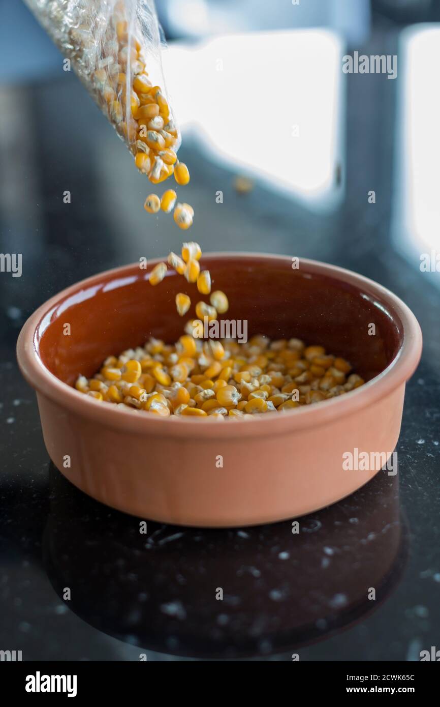 Pouring Pop Corn Into a Bowl Stock Photo - Alamy