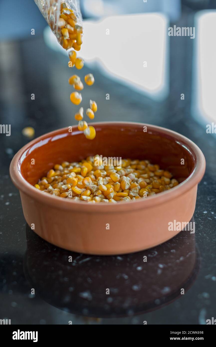 Pouring Pop Corn Into a Bowl Stock Photo - Alamy