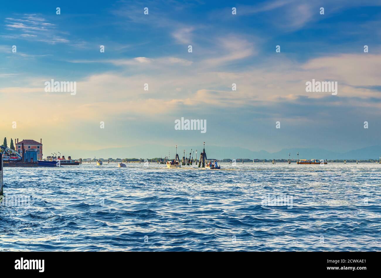 Yacht boats racing sailing on water of Venetian lagoon between wooden ...