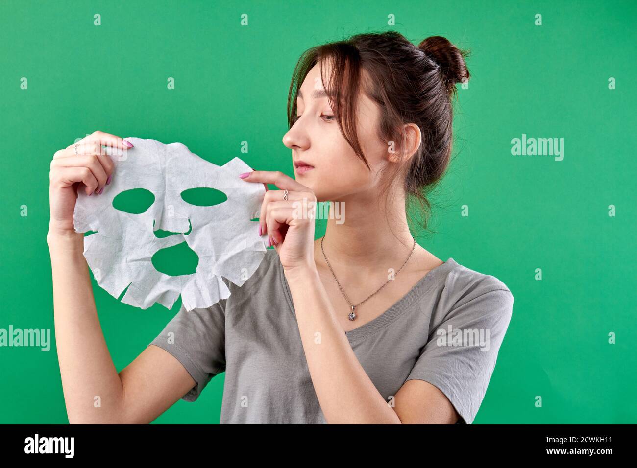 Girl's going to apply spa sheet mask on her face Stock Photo - Alamy