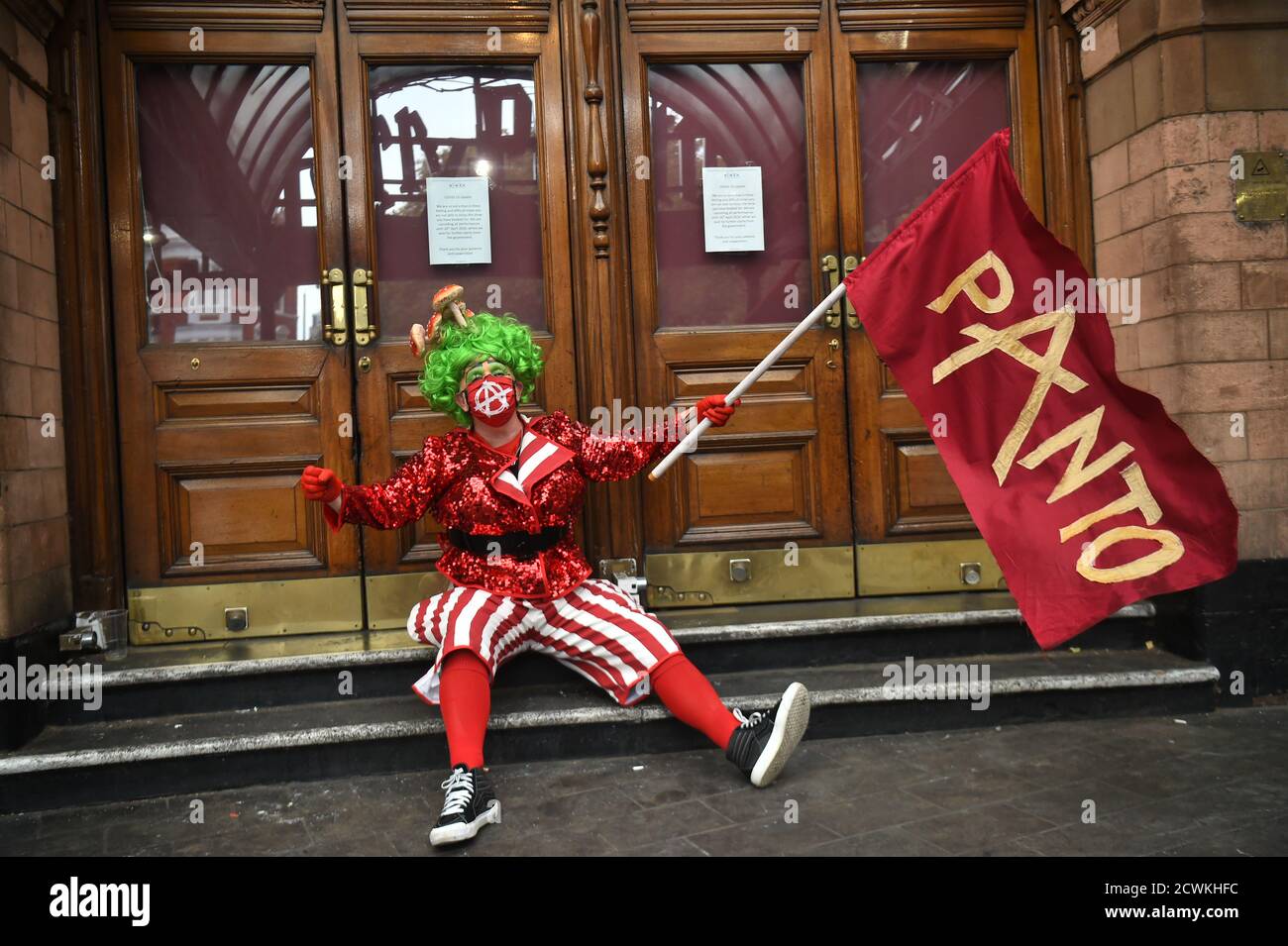 A Pantomine dame in front of the closed doors of the Palace Theatre ...
