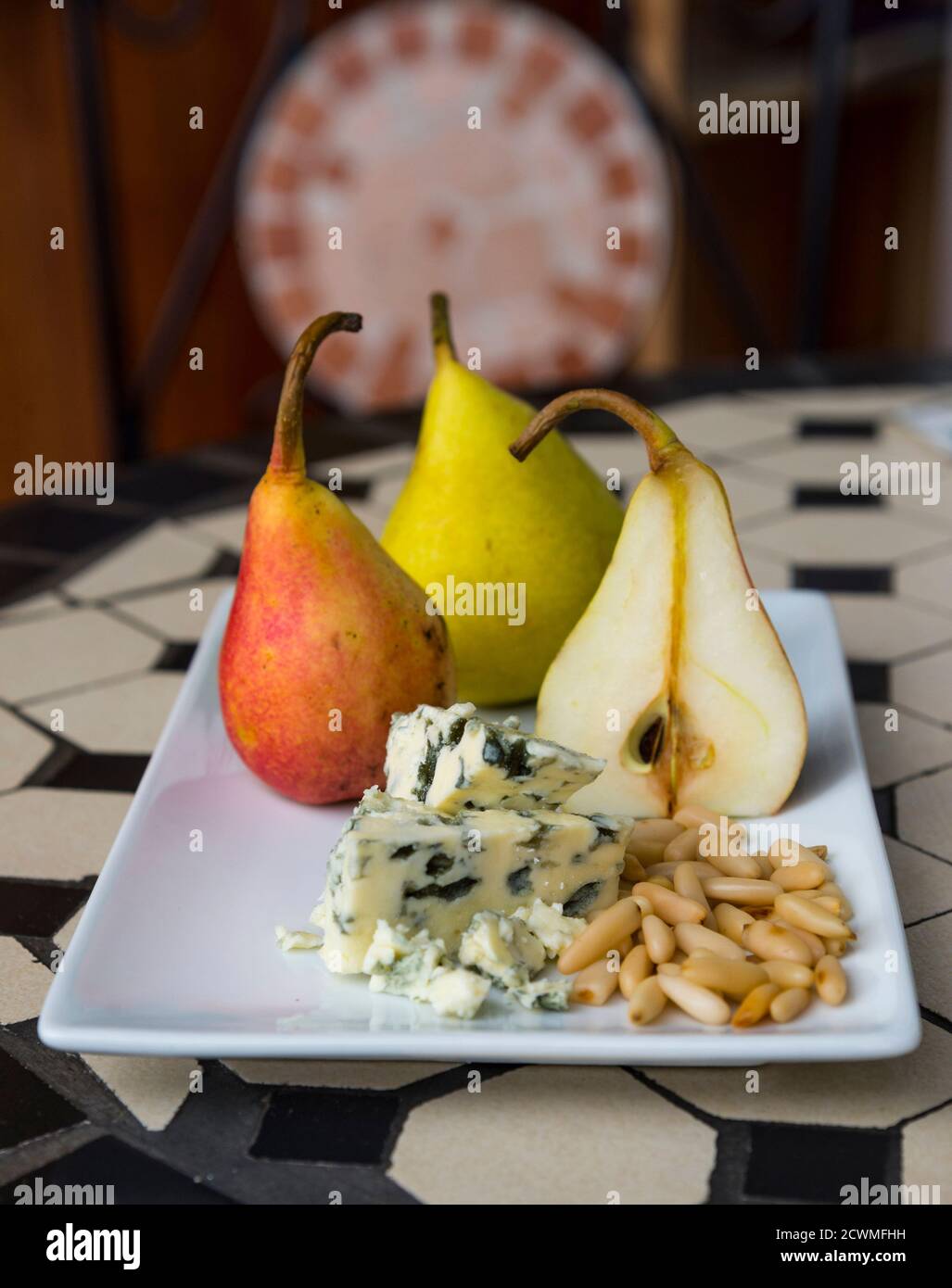 Pieces of blue cheese, pine nuts and pear Stock Photo - Alamy