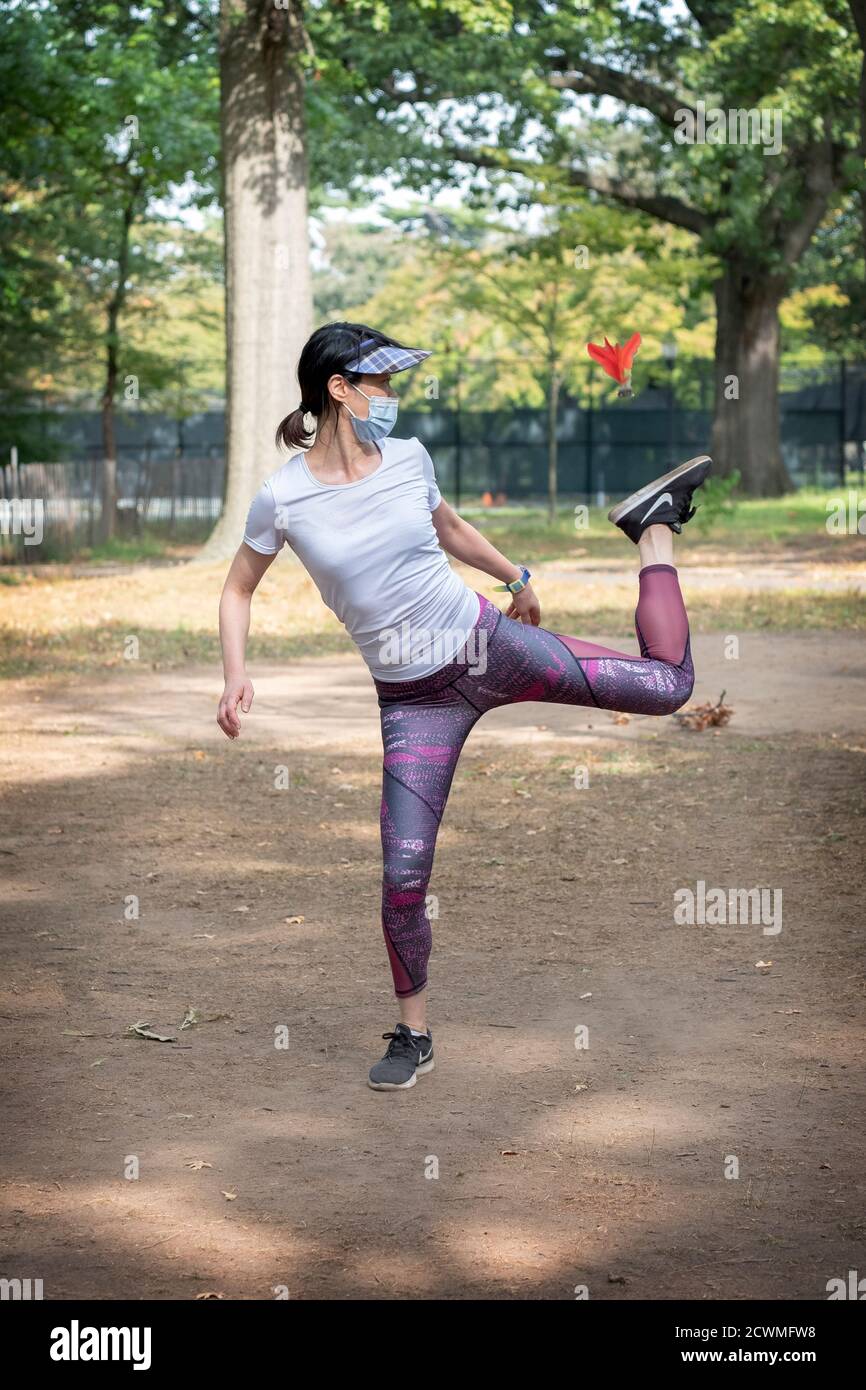 A nimble Chinese American woman plays Jianzi in a park in Queens, New ...